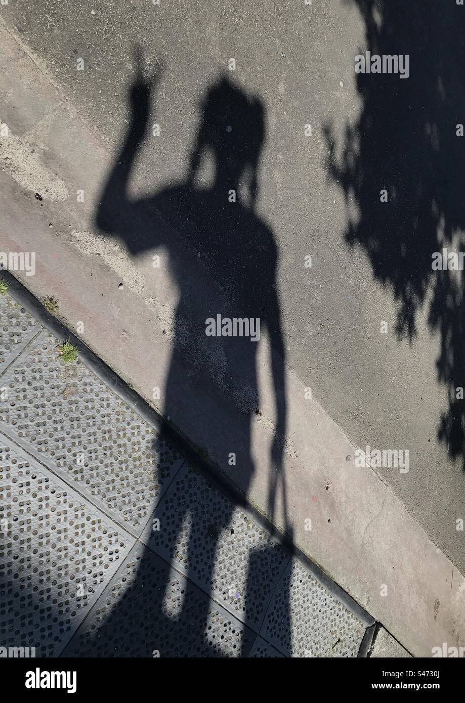 Fun shadow of girl with pigtails holding a bag pulling a peace sign ...