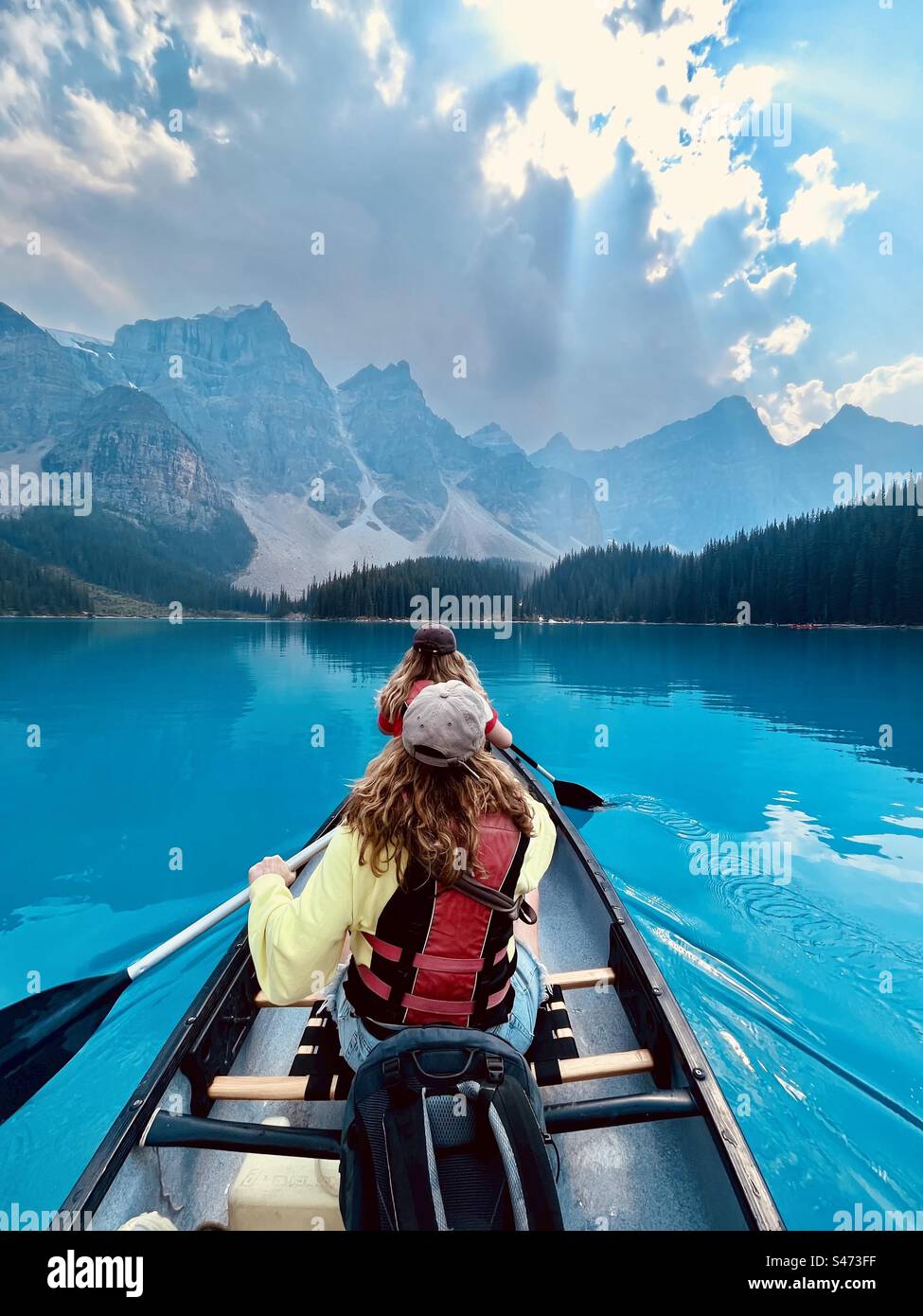 Paddling across the amazing glacial water of Moraine Lake, Banff ...