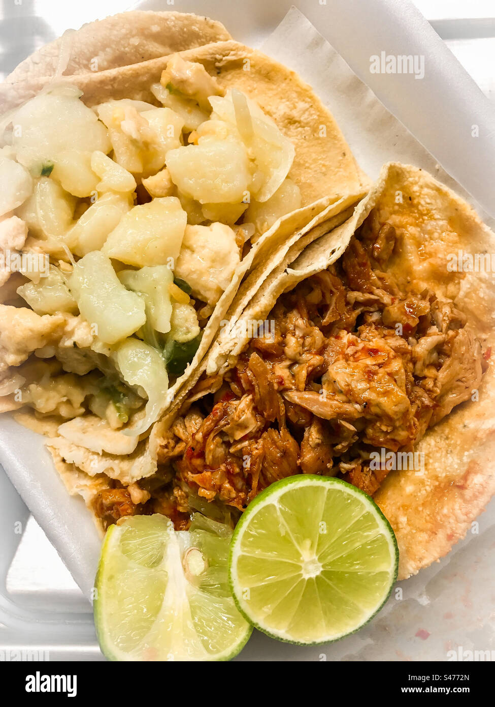 Two tacos with lime pieces, ready to eat Stock Photo - Alamy