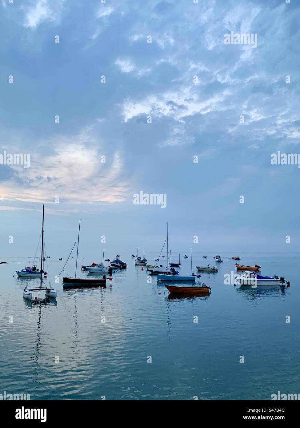 Boats on the still calm sea Stock Photo - Alamy