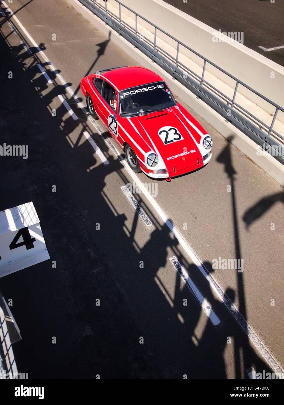 1960s Porsche 911 in the pit lane at Goodwood motor racing circuit UK ...