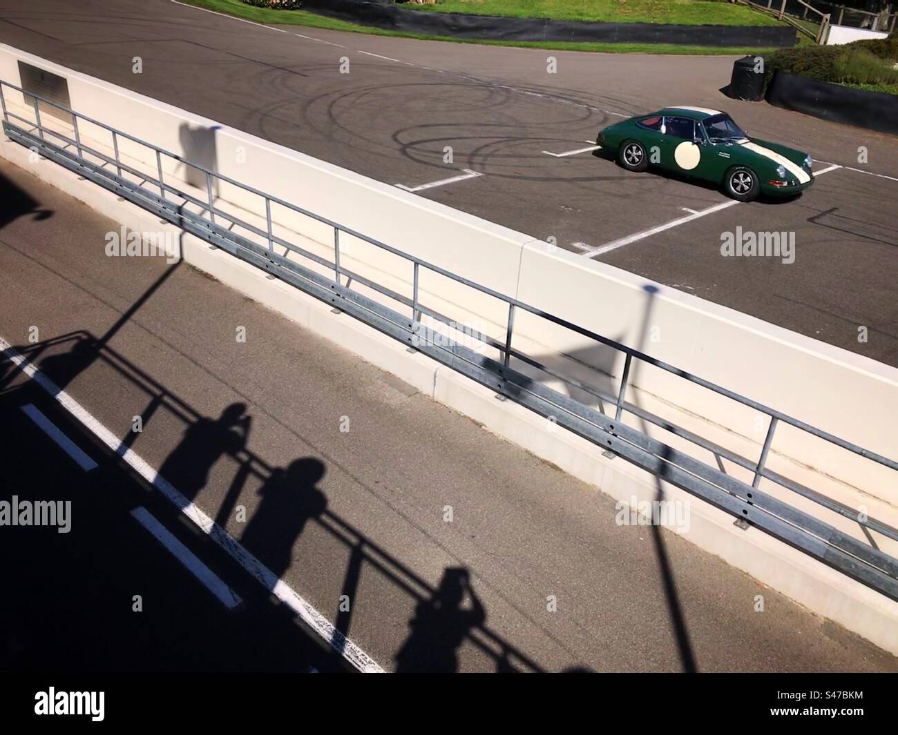 1960s Porsche 911 on the start finish straight at Goodwood motor racing ...