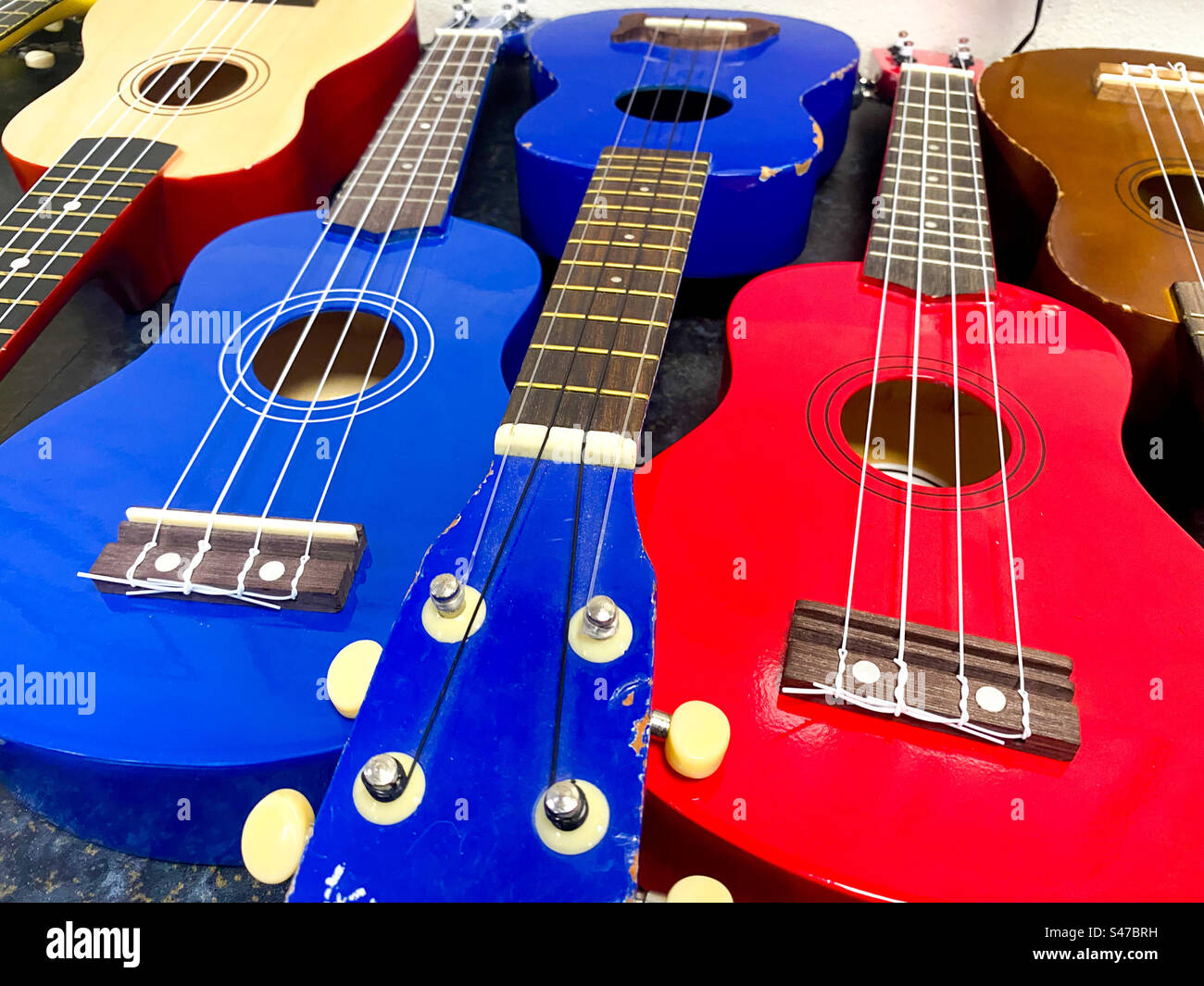 Colourful ukulele string instruments Stock Photo - Alamy