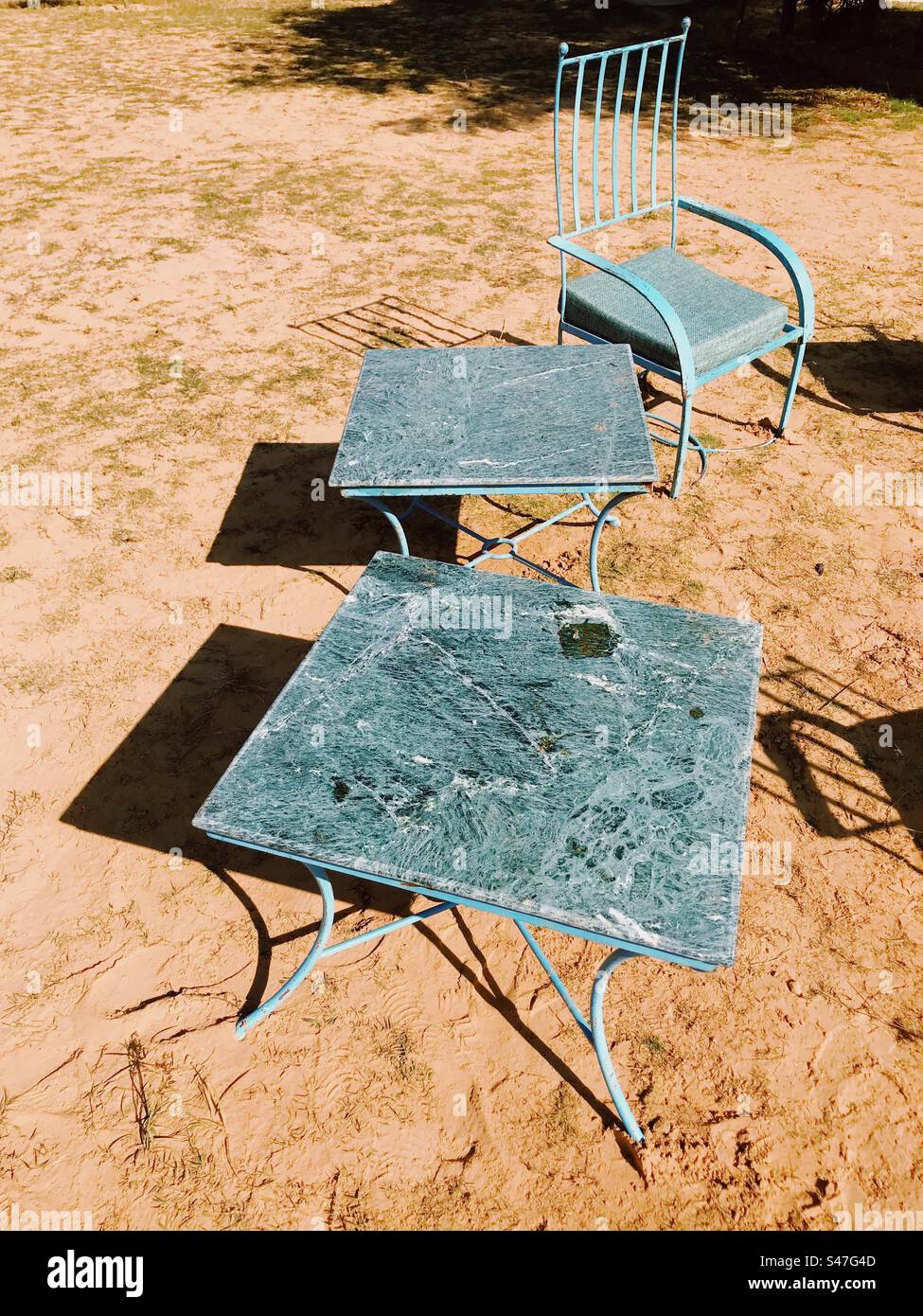 Garden tables and chair out in the sun Stock Photo - Alamy