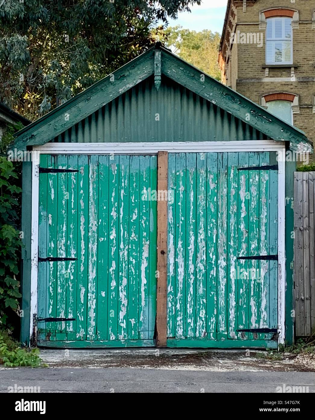 Green corrugated iron garage Stock Photo - Alamy