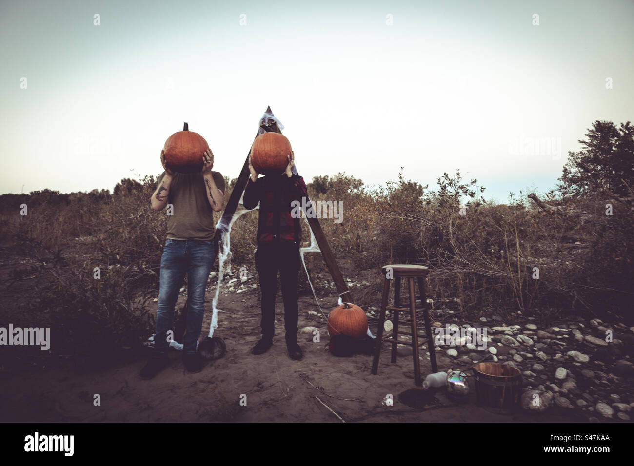 Two men with pumpkin heads. Spooky Halloween photos Stock Photo - Alamy