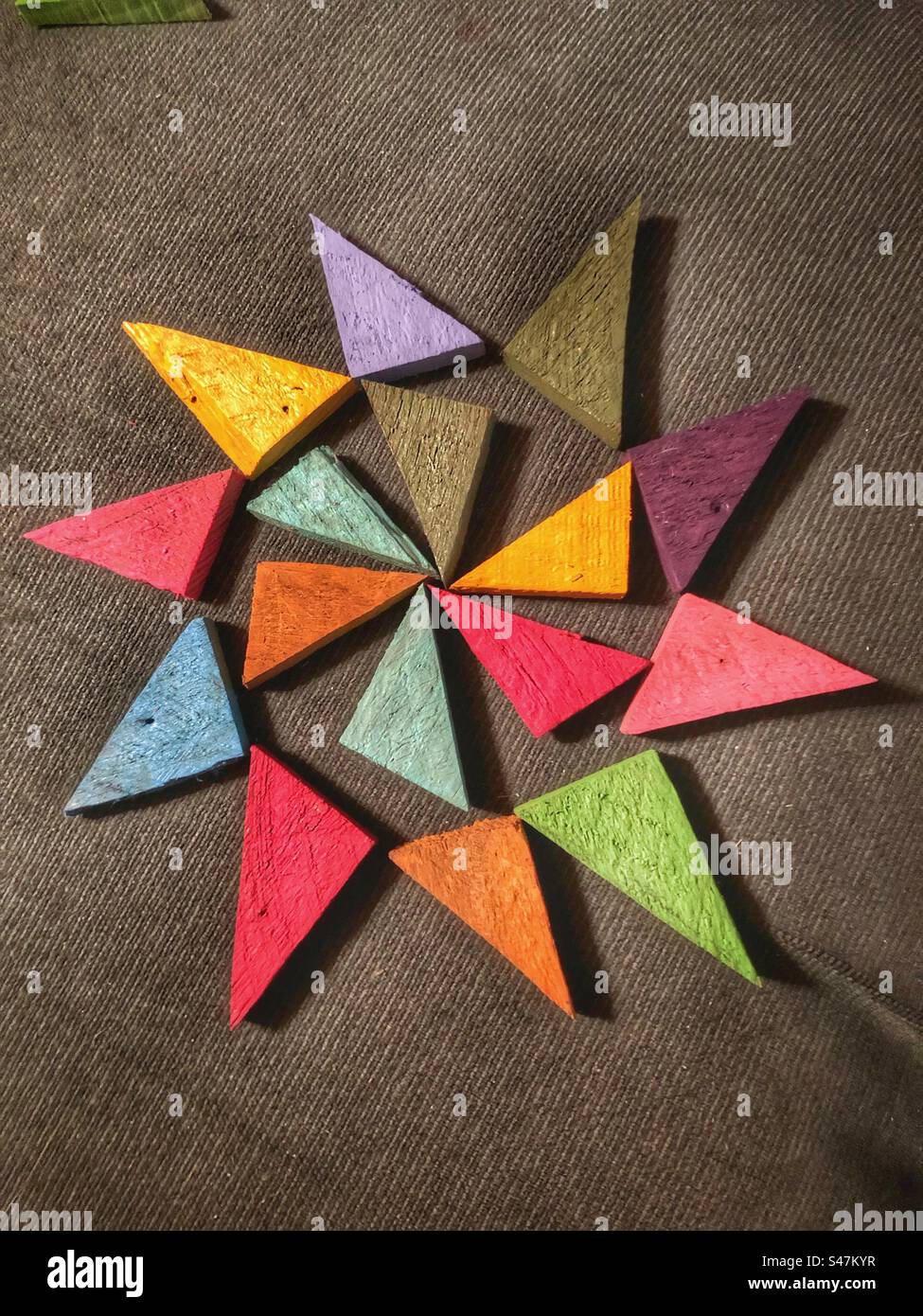 Hand made and painted wooden triangles Stock Photo - Alamy