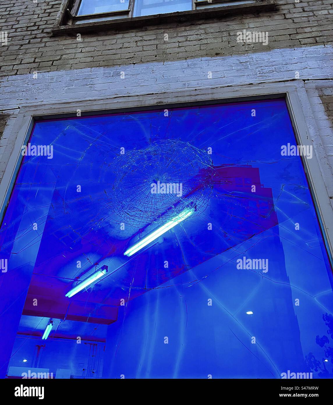 Blue lights reflect in window London Whitechapel Stock Photo - Alamy
