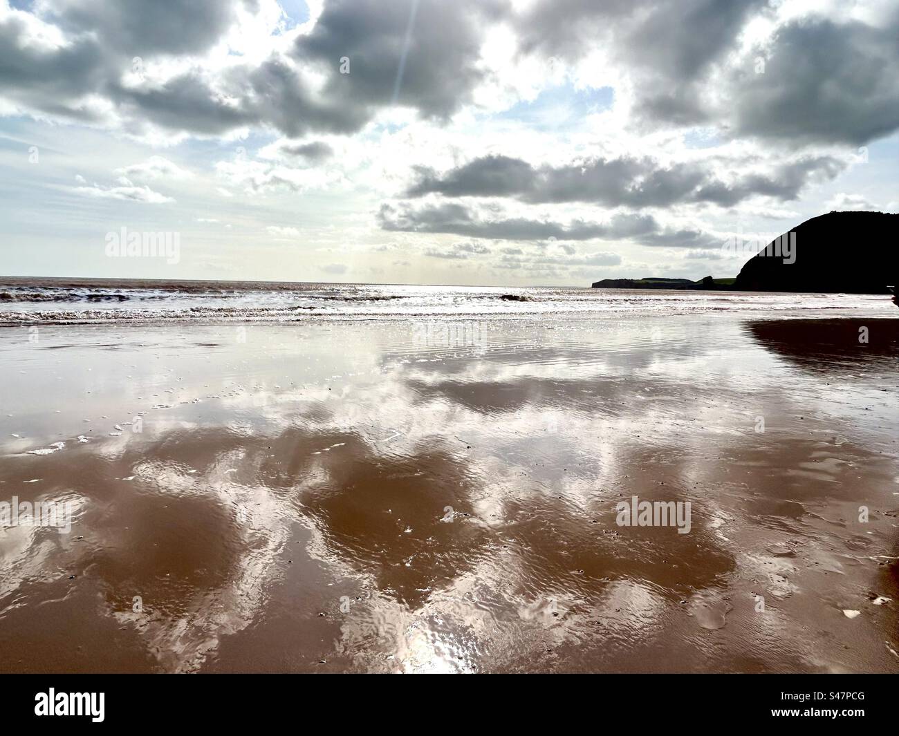 Reflections of clouds on the wet sand Stock Photo - Alamy