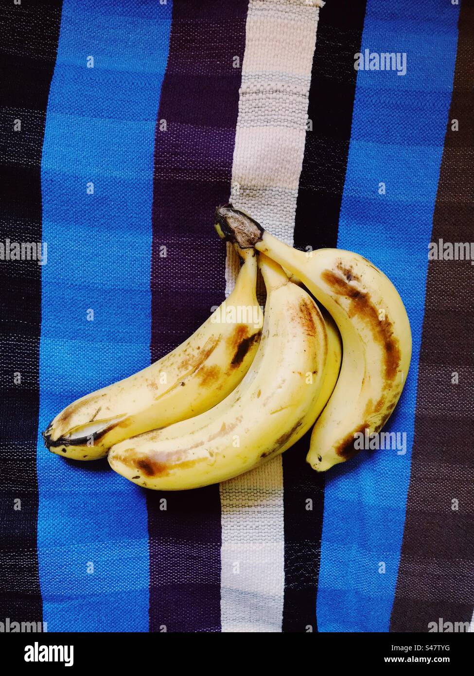 Bananas on a striped background Stock Photo - Alamy