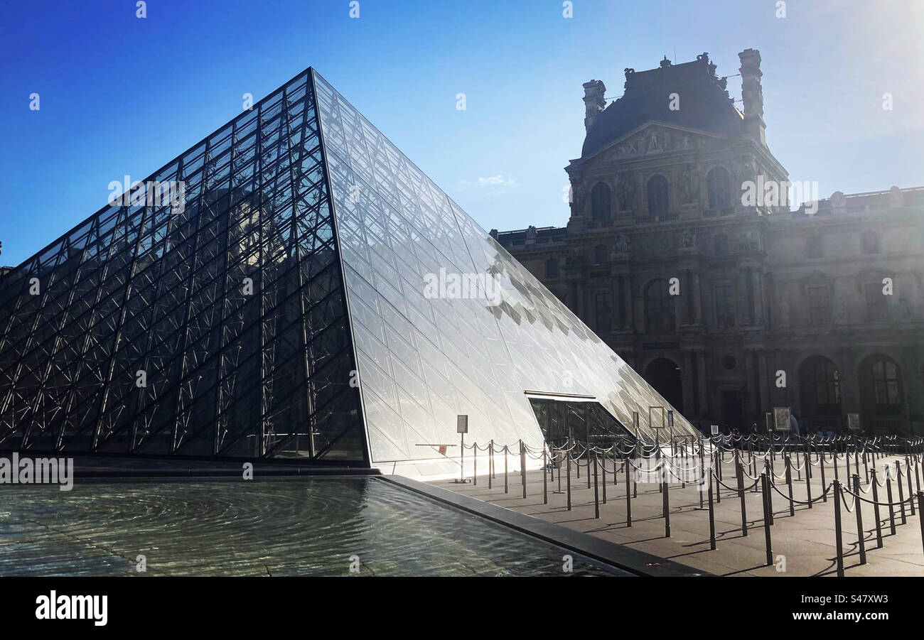 The sun shining on the Louvre pyramid in Paris Stock Photo - Alamy