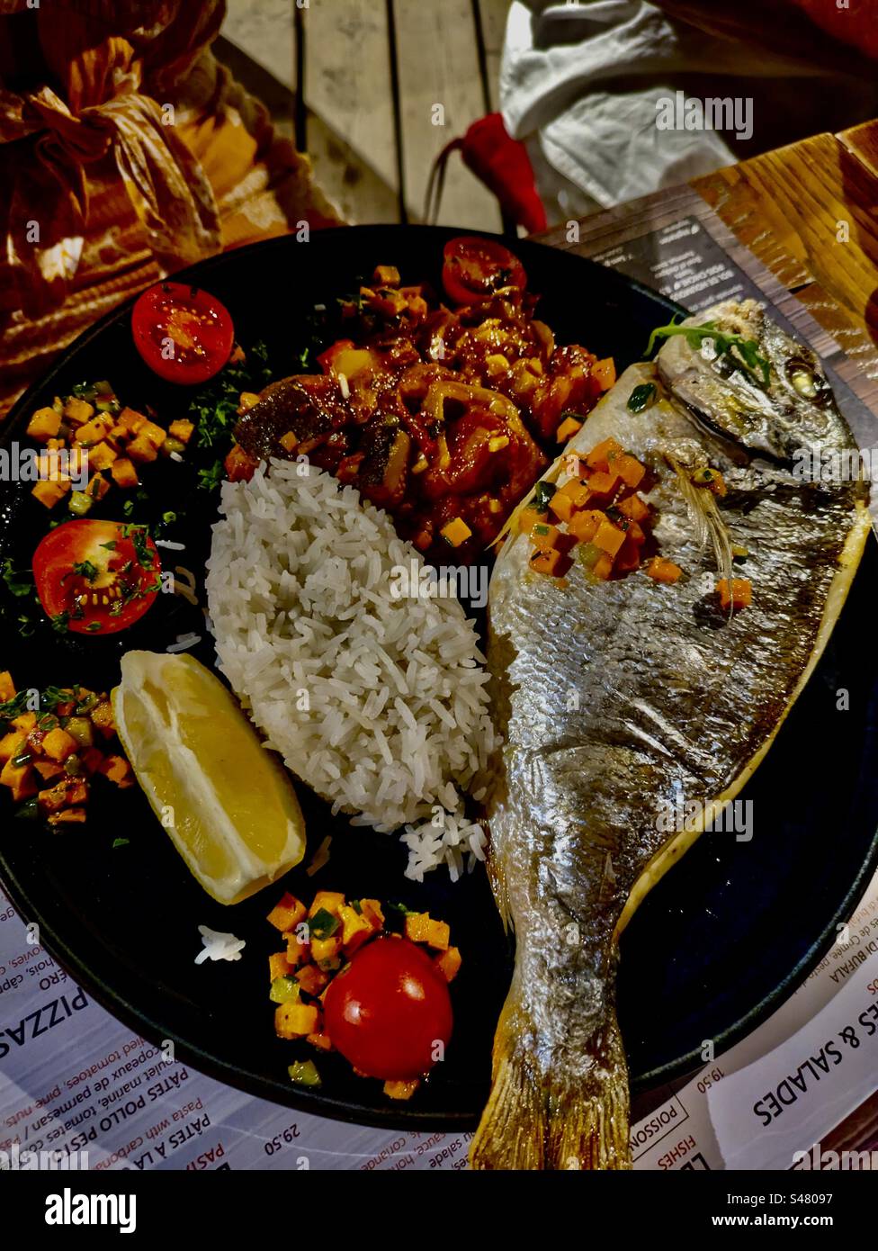 Fish dinner with rice and tomatoes hi-res stock photography and images ...