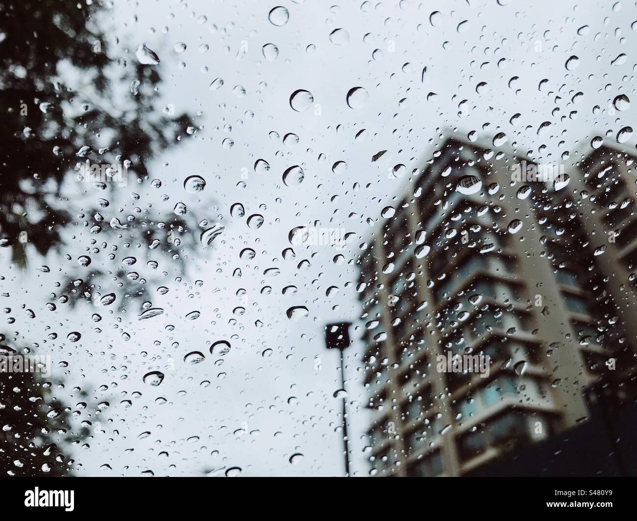 A residential apartment building in Mumbai, India with rain drops in ...