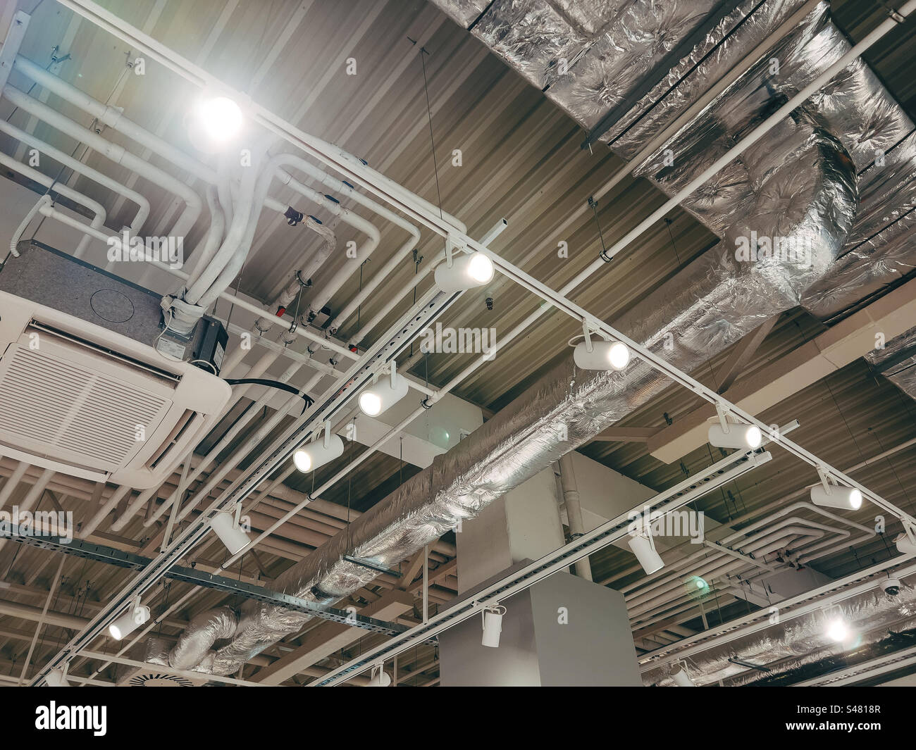 Shopping mall store ceiling with light and air conditioning pipes Stock ...