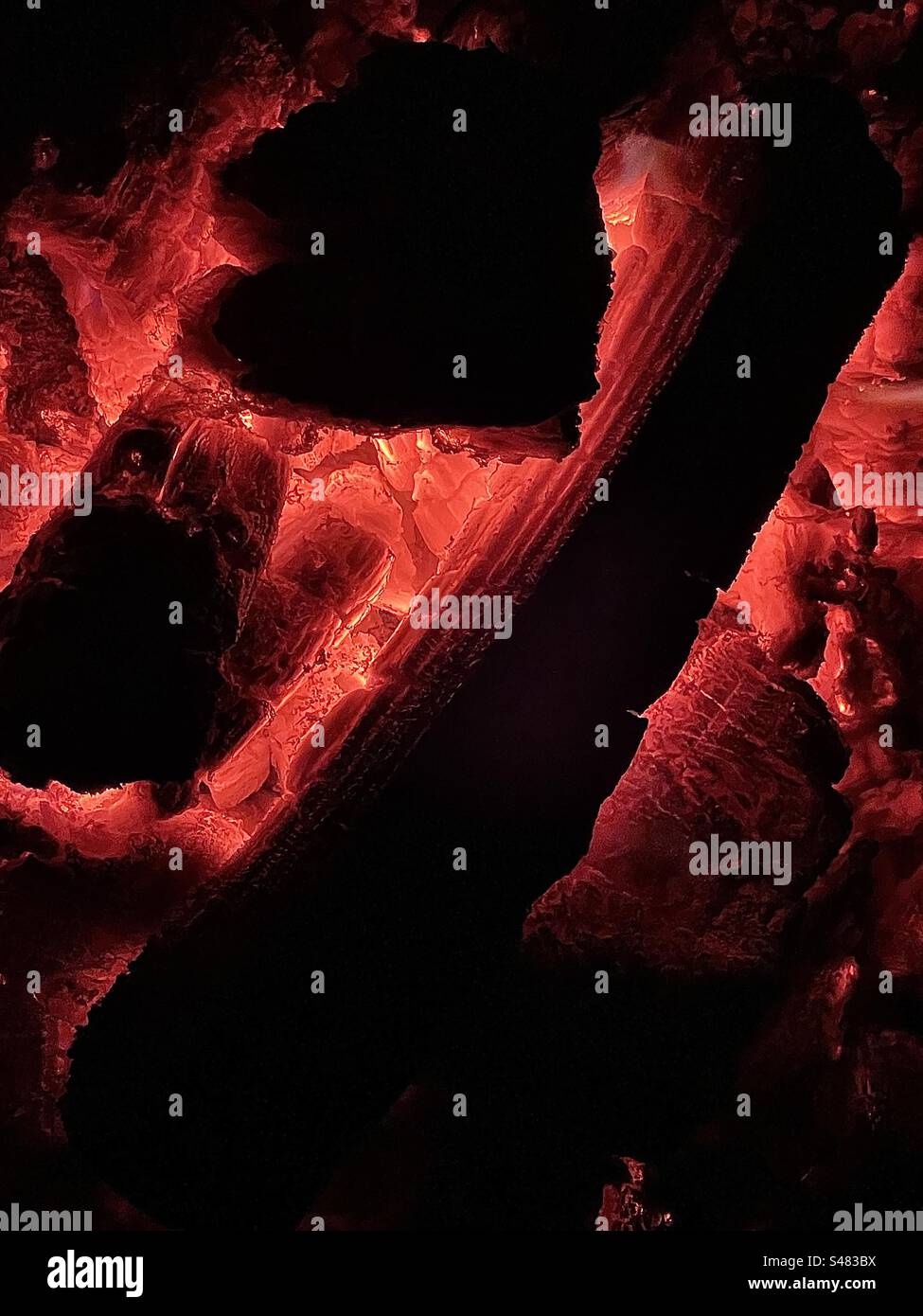 A closeup view of the inside of an outdoor fire pit. The wood has ...