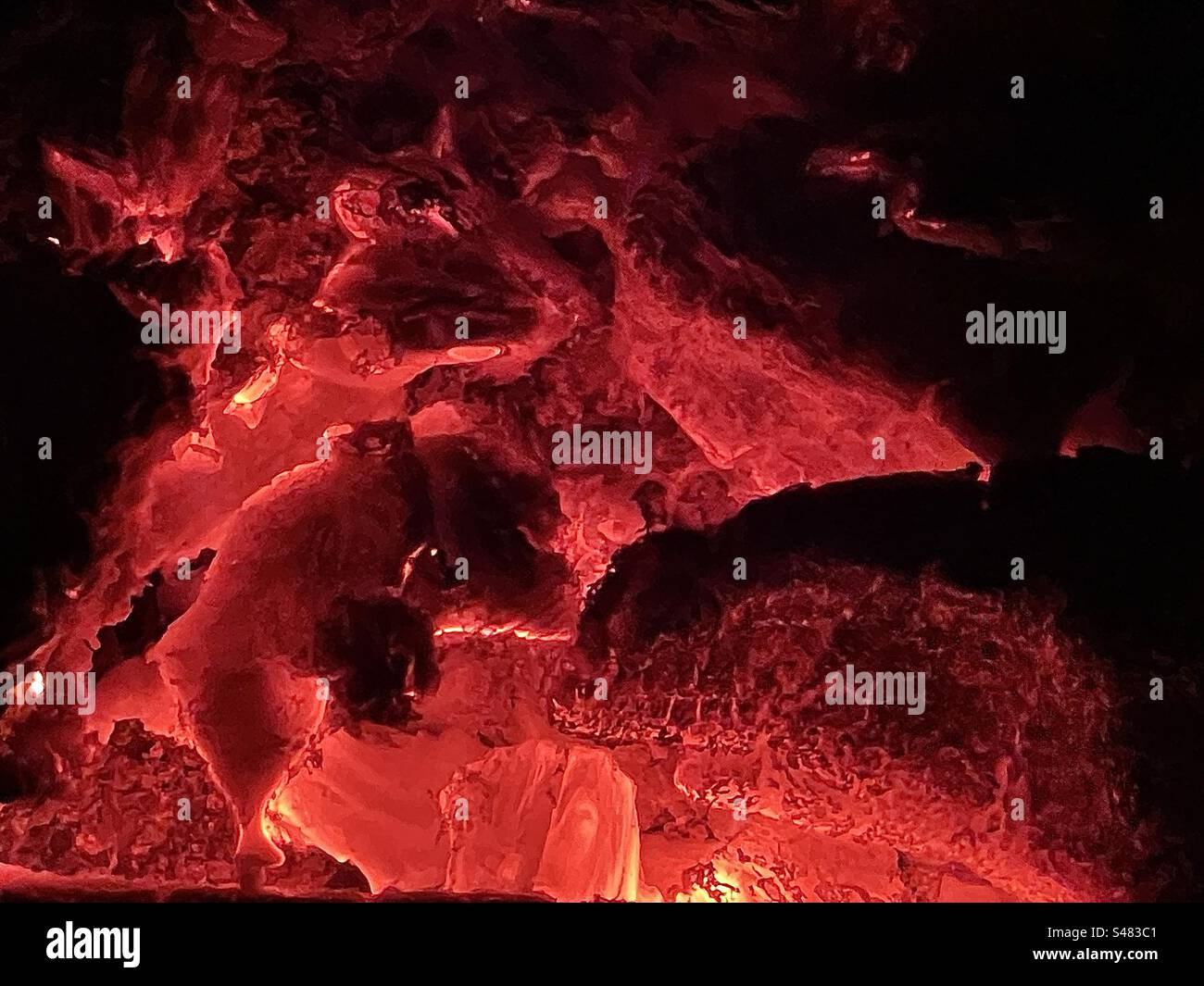 A closeup view of the inside of an outdoor fire pit. The wood has ...