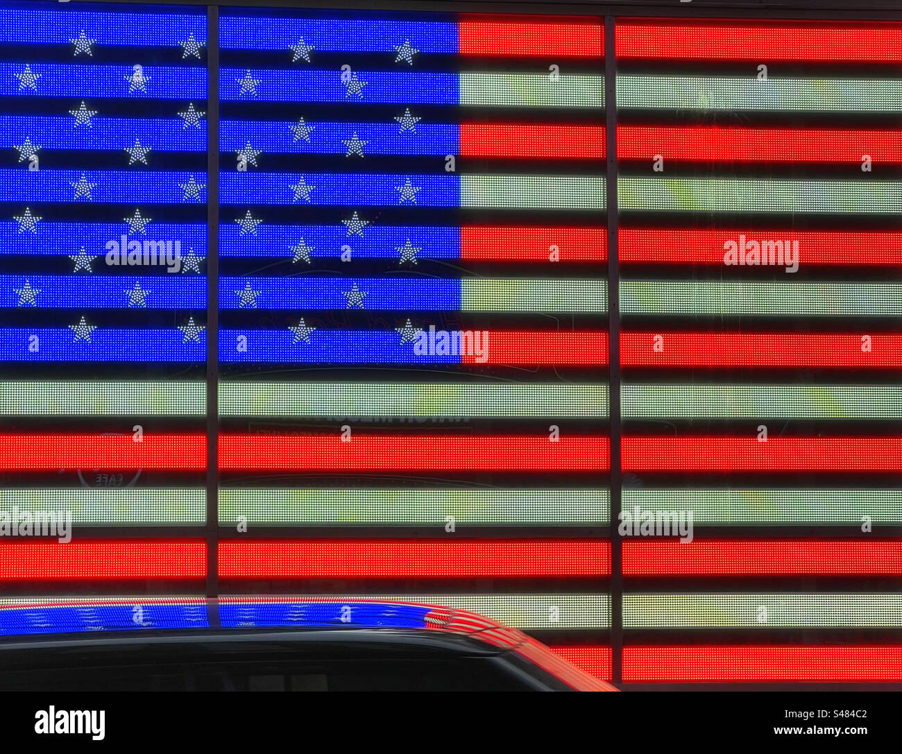 LED Stars and Stripes flag reflected in roof of car in Times Square ...