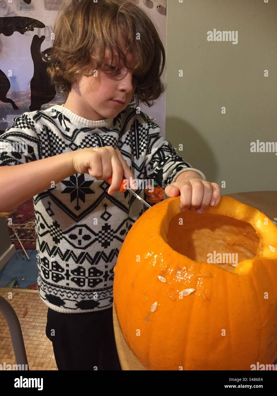 Boy carving a large pumpkin Stock Photo - Alamy