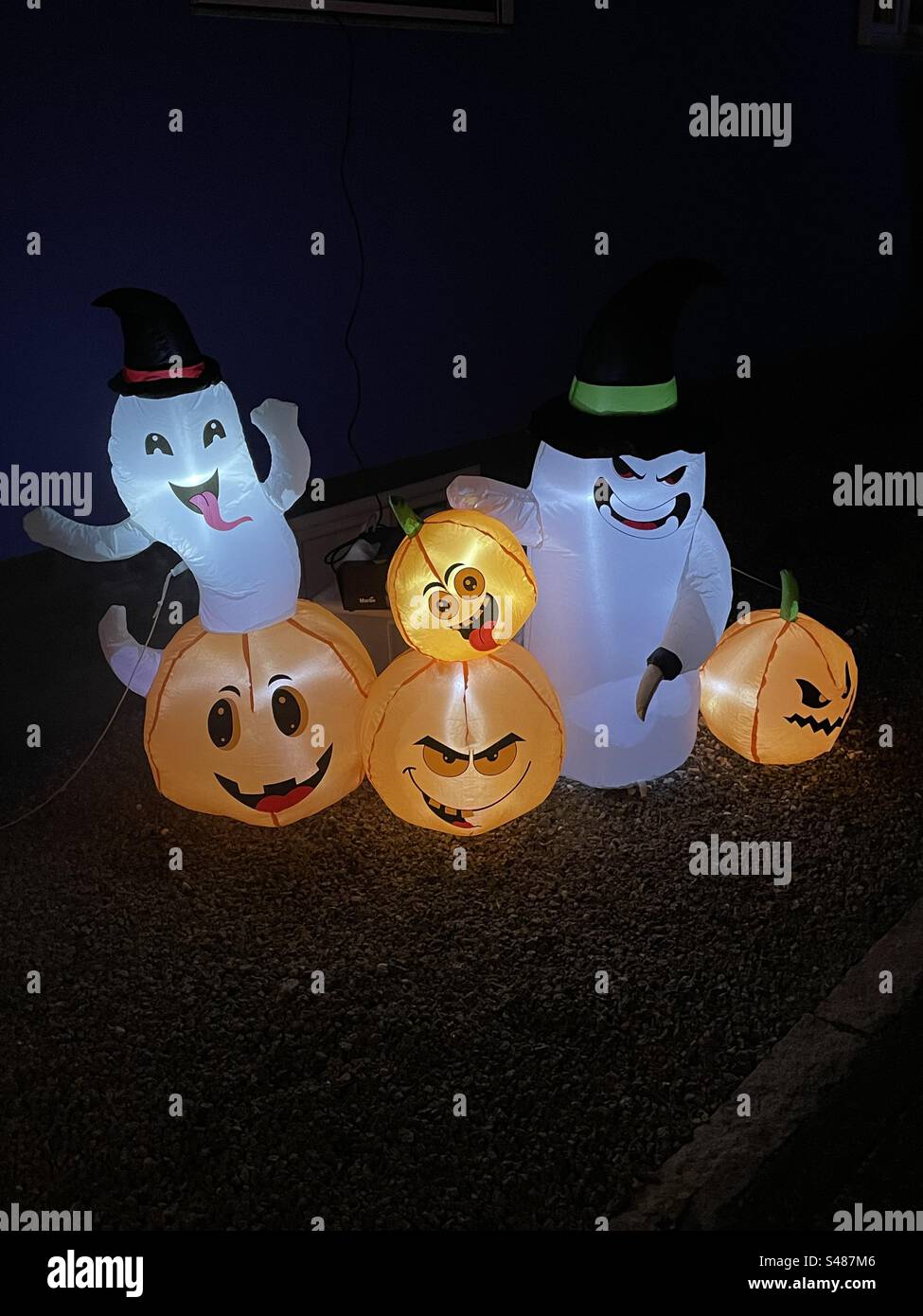 A Halloween-themed display featuring ghost and pumpkin figures, setting ...