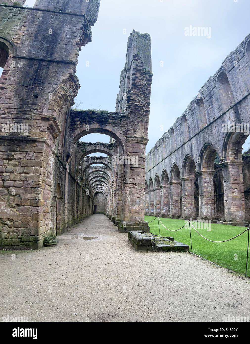 Fountains abbey interior stone walls with paths and grass areas Stock ...