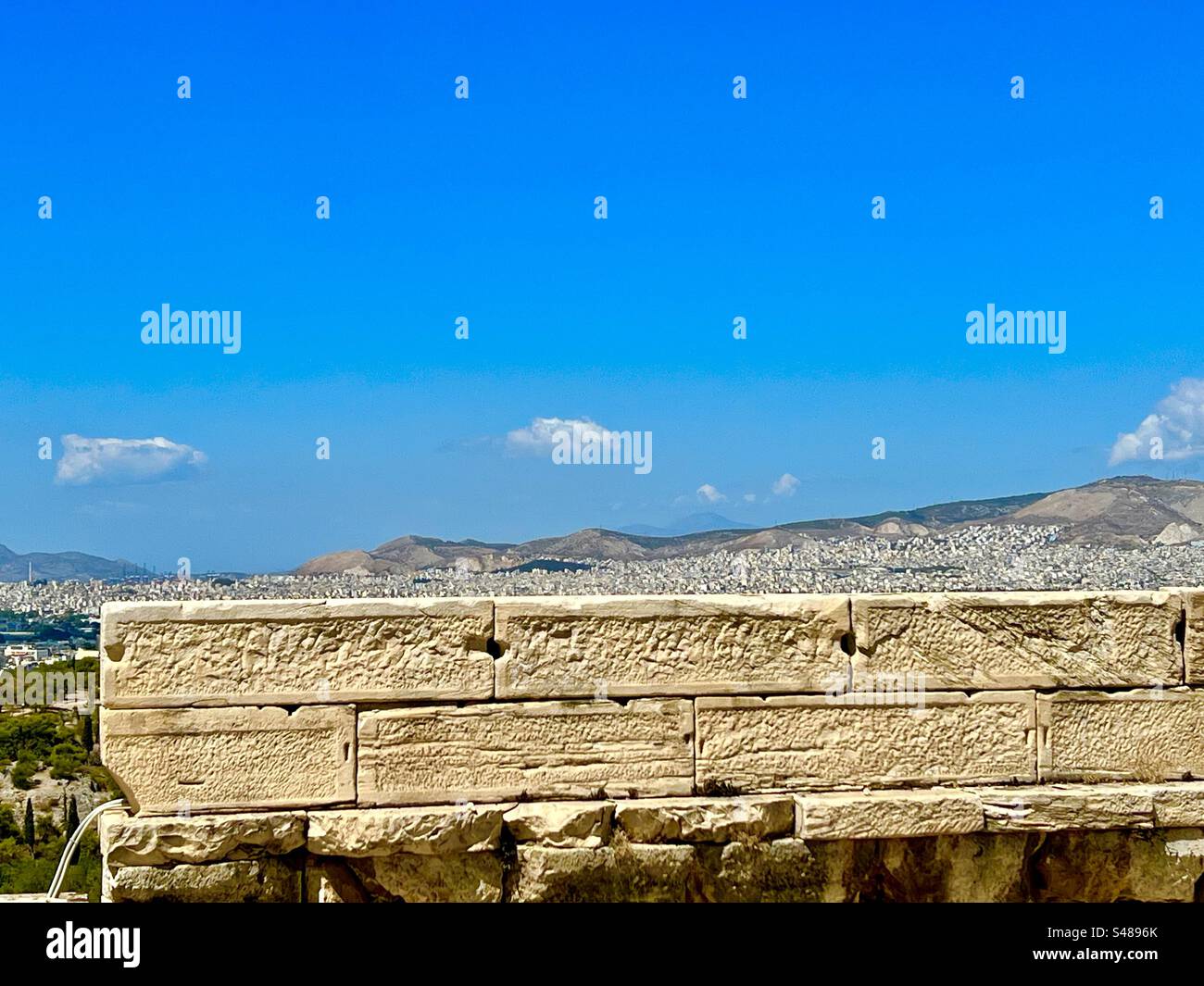 Blue summer sky and the city of Athens behind layer of marble blocks on ...
