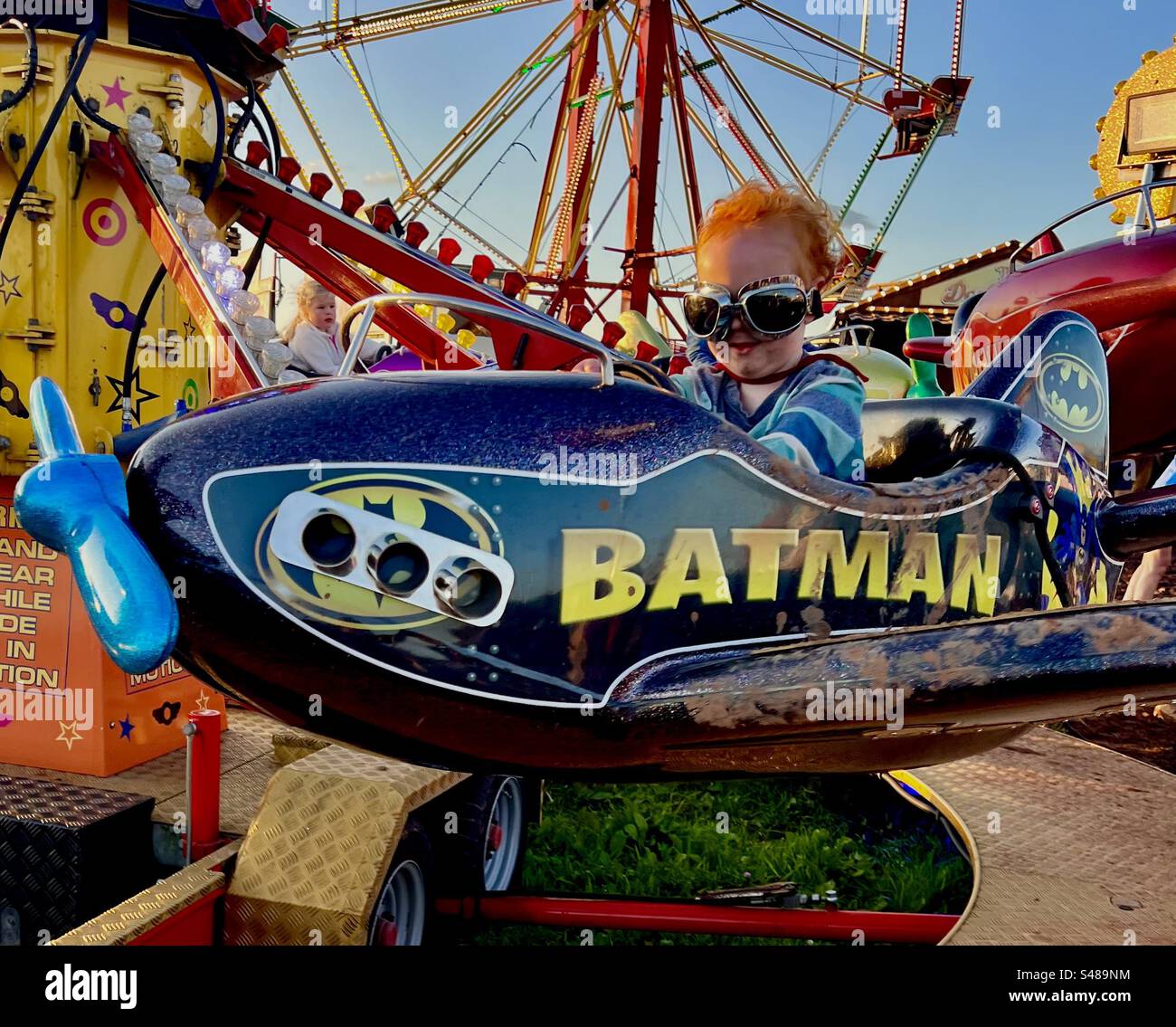 A kid being a rebel on a funfair ride Stock Photo - Alamy