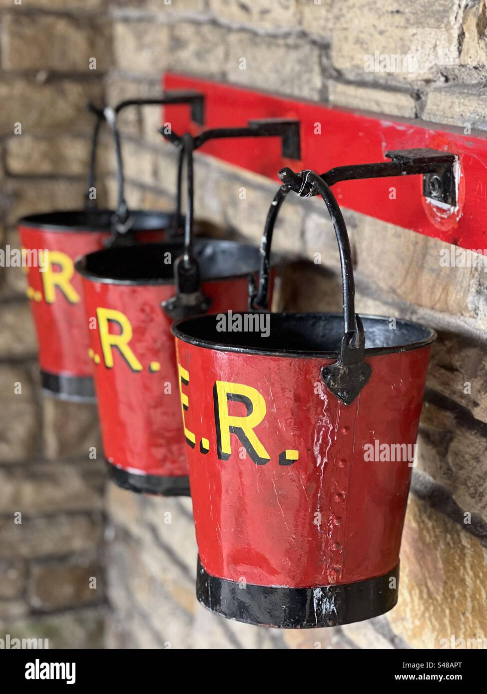 Beamish - bright red old fashioned fire buckets at the train station ...