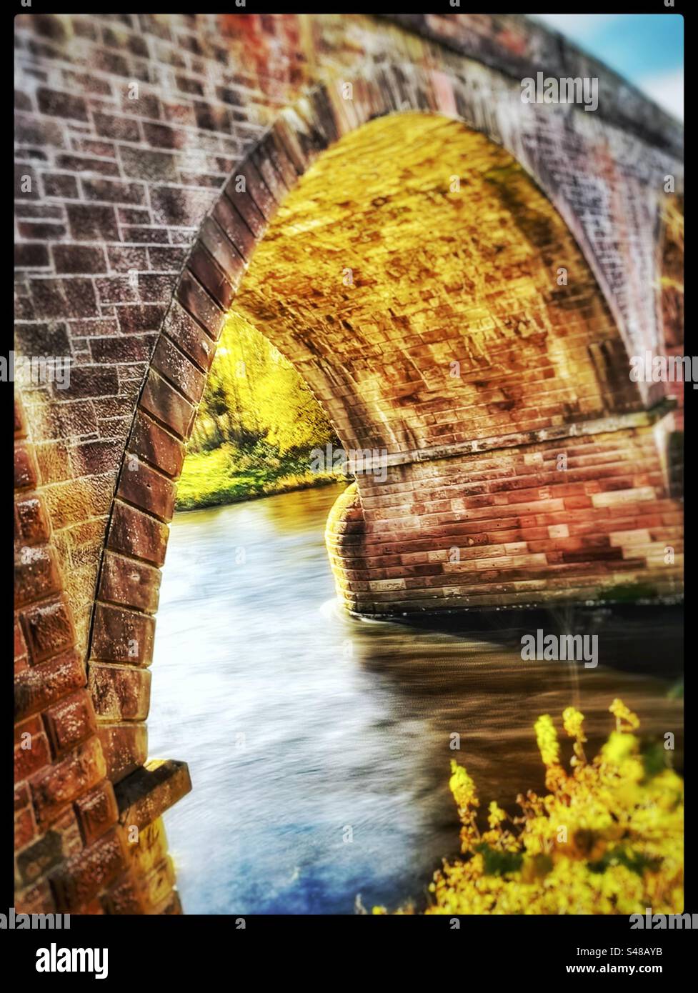 Fast water flowing underneath a railway bridge at Tweedbank Stock Photo ...