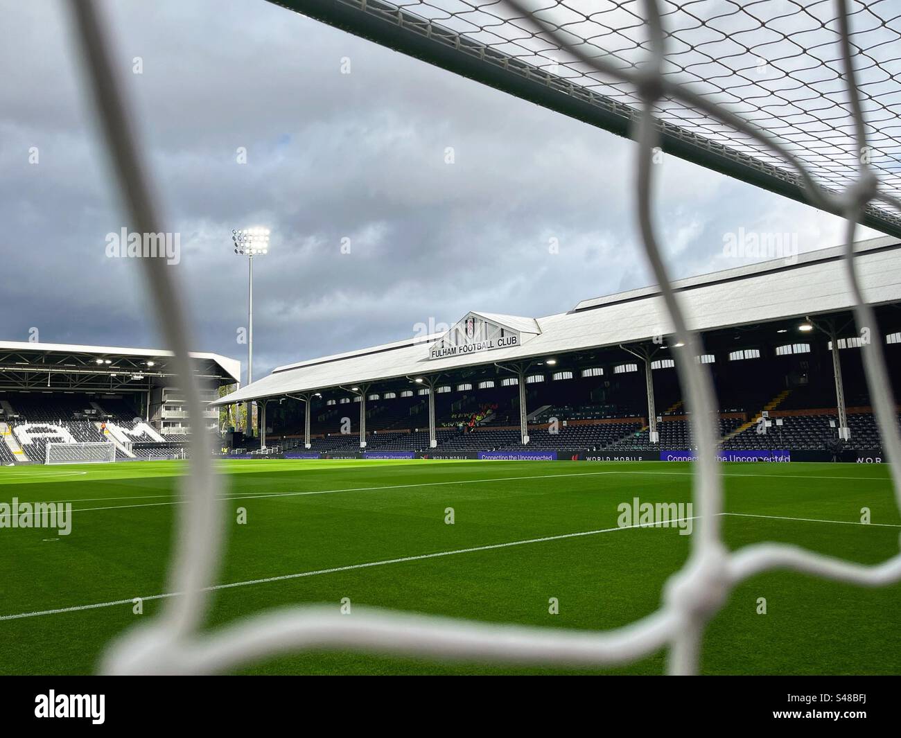 The football pitch and grandstand are seen through the goal net at ...