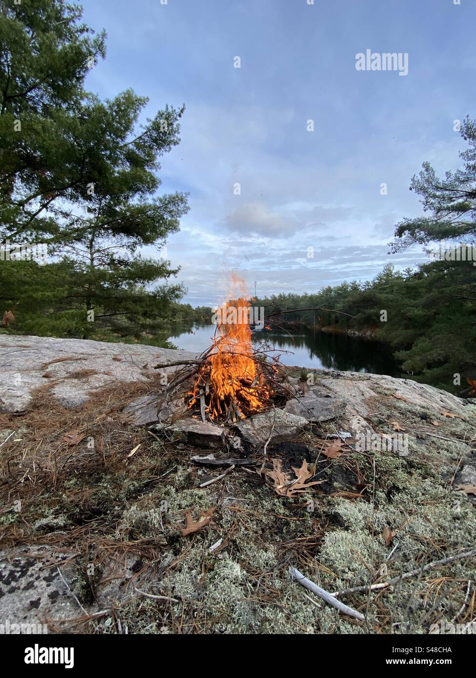 Fire on a cliff over looking a lake, started with magnesiums and steel ...