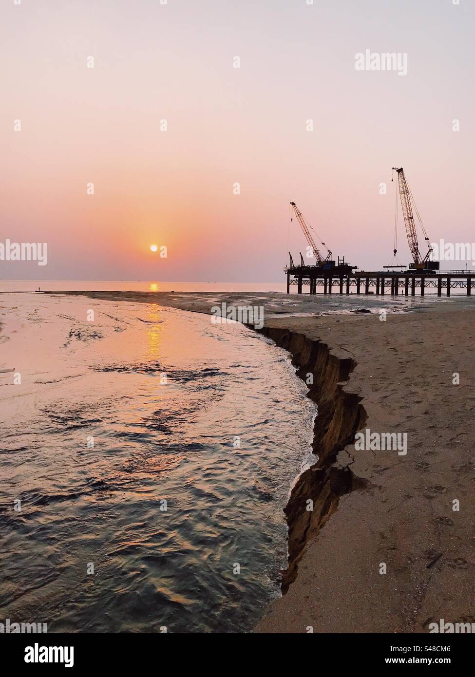 Road construction work on a beach during sunset Stock Photo - Alamy