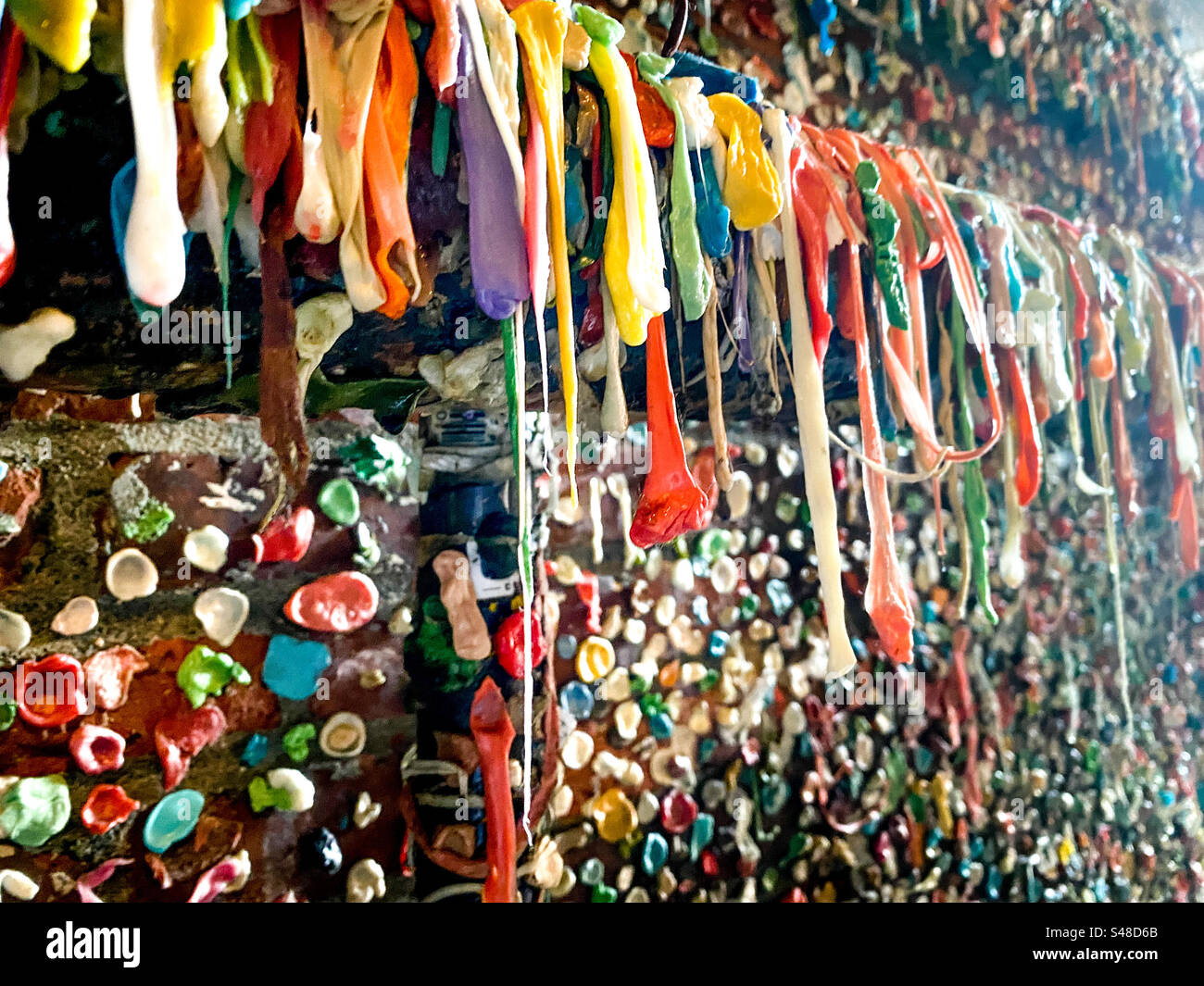 Closeup of gooey stretched gum hanging from ledge in the iconic and ...
