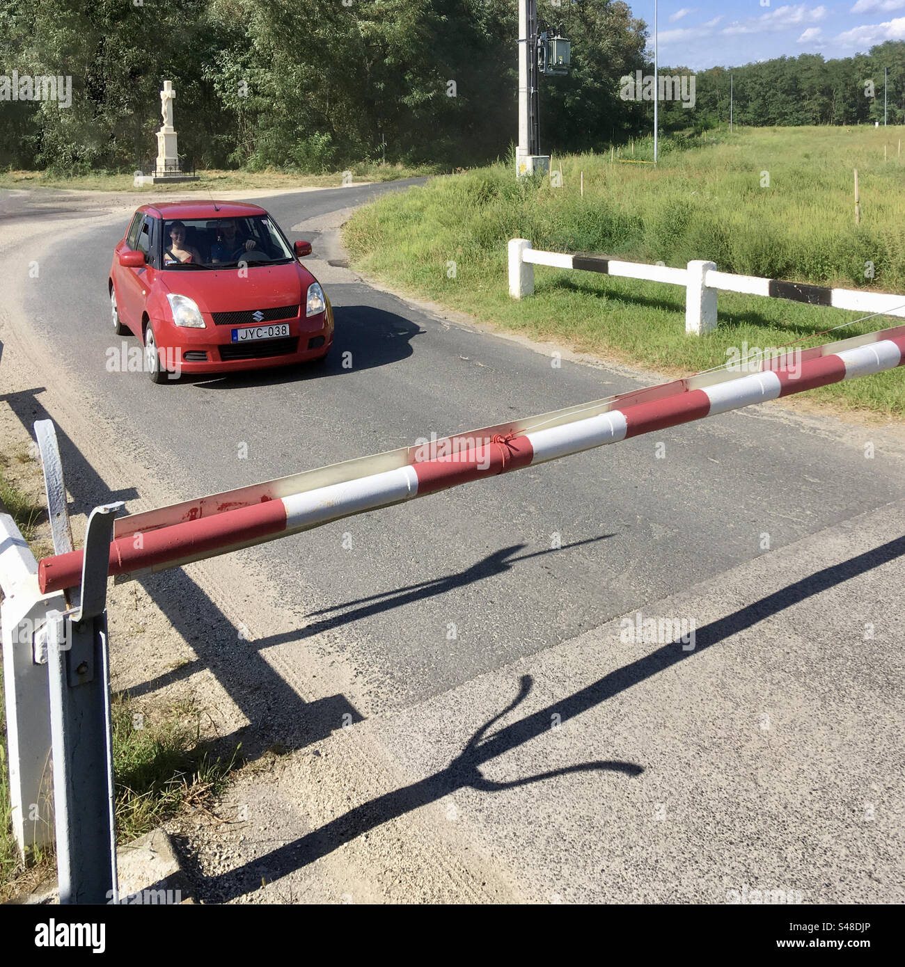 Car waiting at level crossing seen from train Stock Photo - Alamy