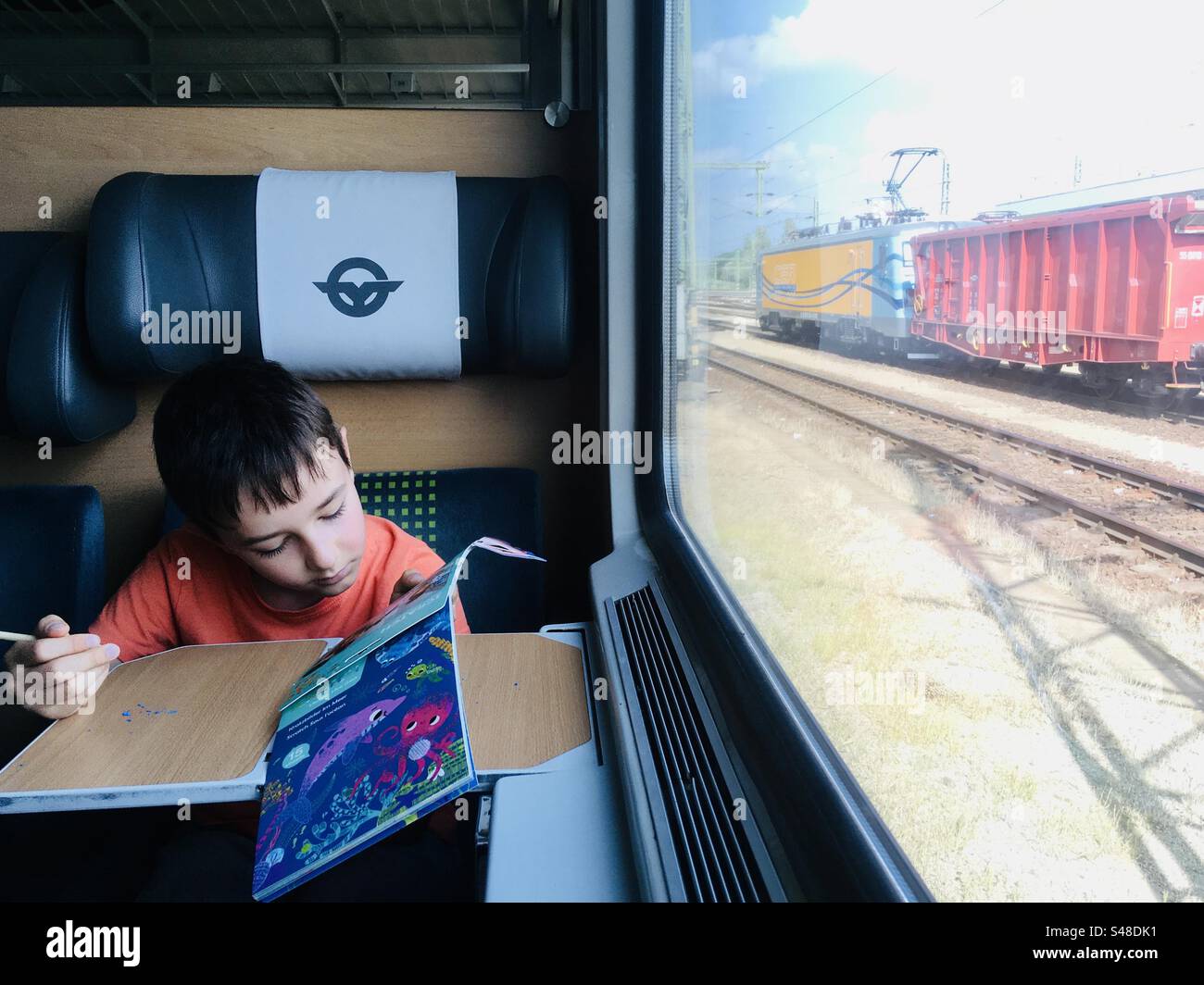 Child reading sitting in GYSEV passenger carriage train at Budapest ...
