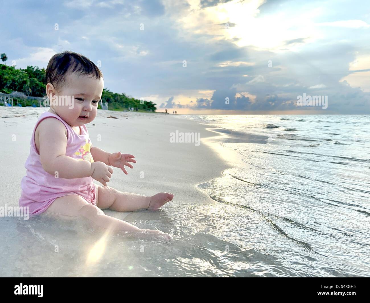 Baby girl sees the ocean for the first time. Varadero, Cuba Stock Photo ...