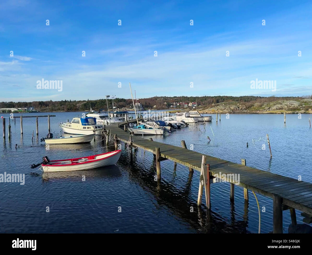 Pleasure boats beside a wooden pier on Donsö, an island in the southern ...