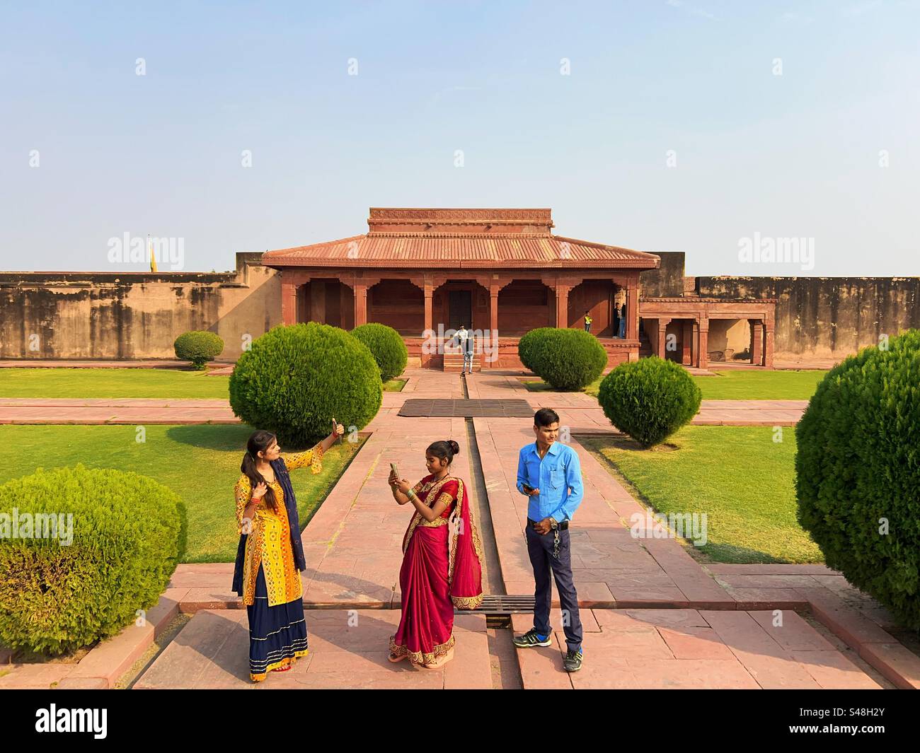 Indian tourists dressed in bright coloured traditional clothes clicking ...