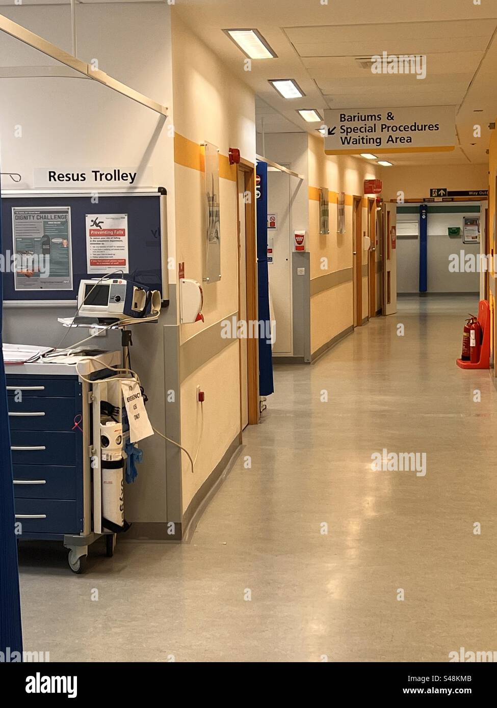 Empty Hospital Corridor With Resus Trolley And Barium Preparation Stock
