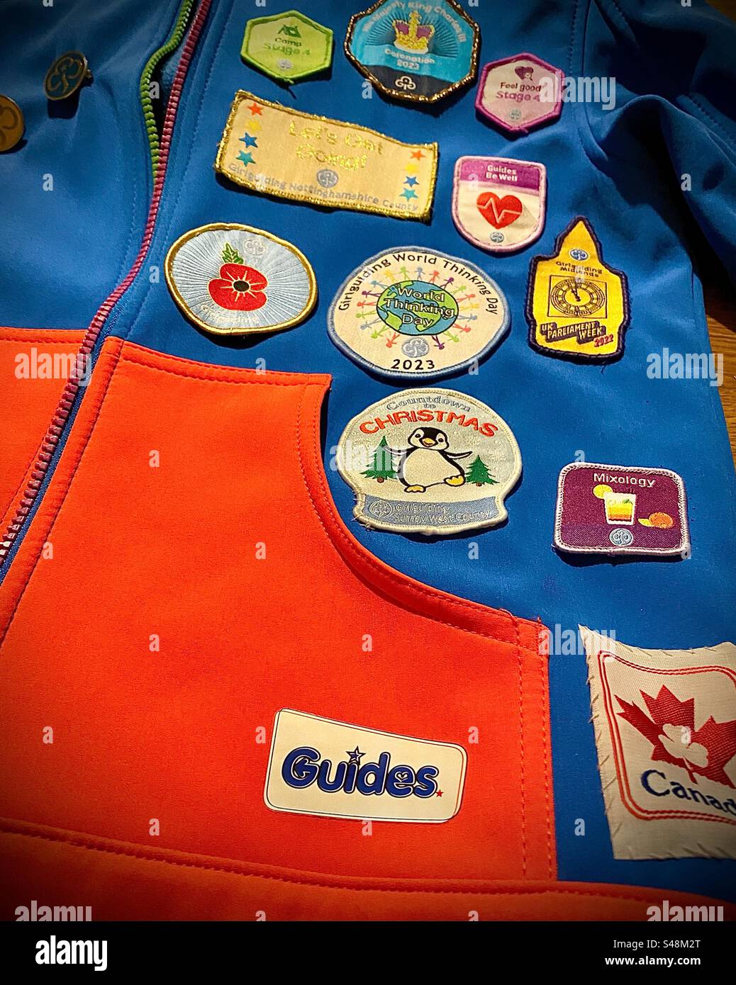 Selection of Girl Guide badges sewn onto jacket Stock Photo - Alamy