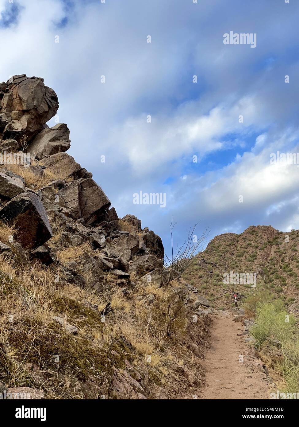 Rock cliffs against cloudy blue sky, Cholla trail, Camelback Mountain ...