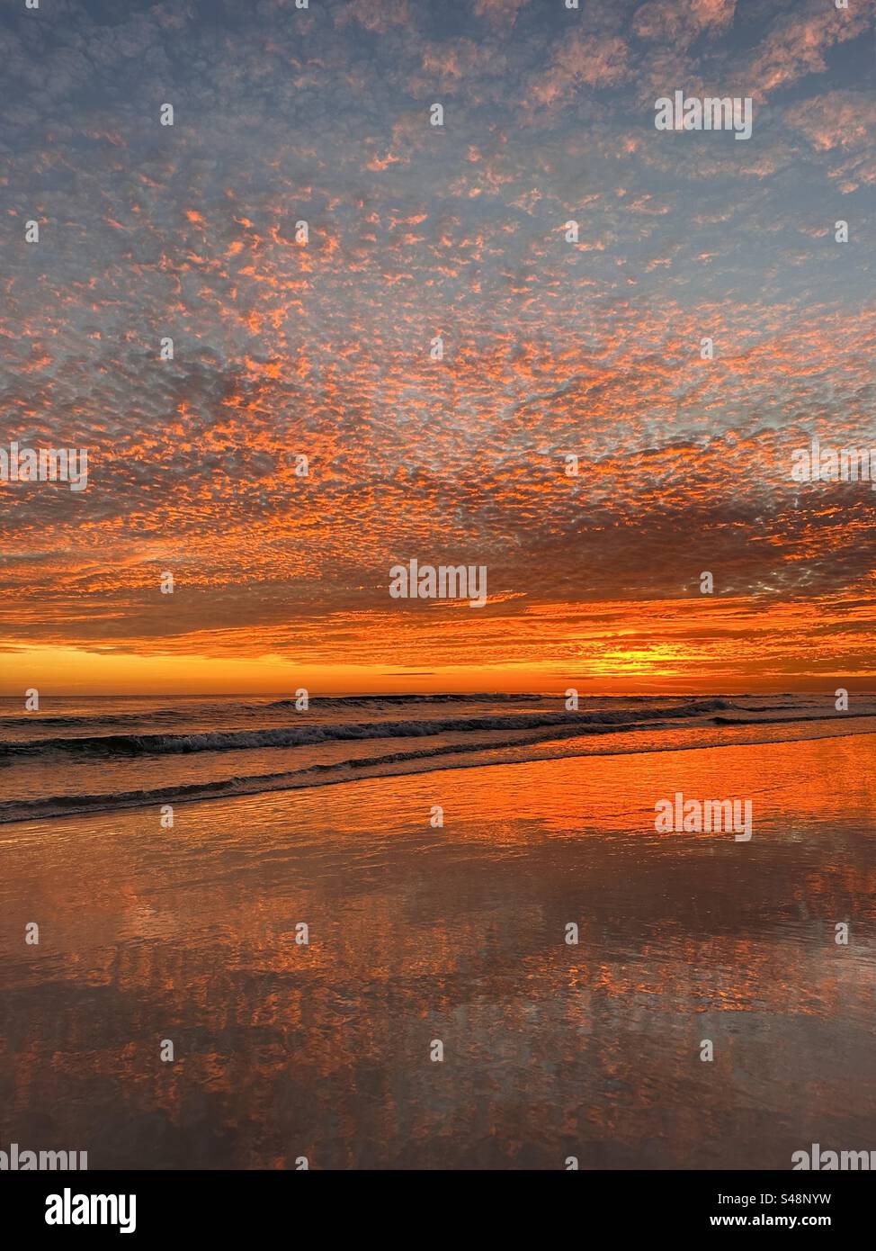 Vibrant sunset skies and reflections over the Gulf of Mexico Miramar ...