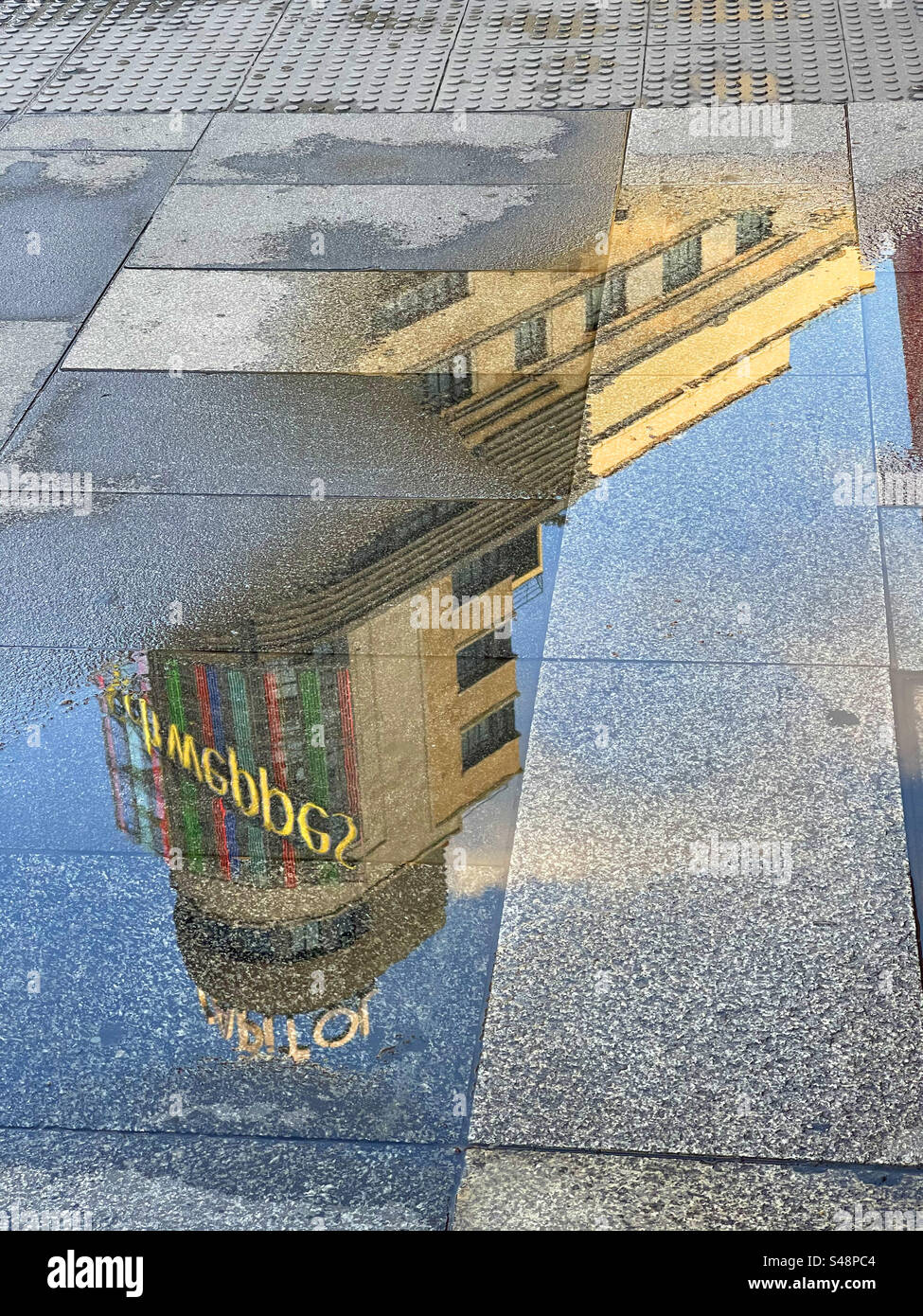 Capitol building reflected on puddle. Gran Via street, Madrid, Spain ...