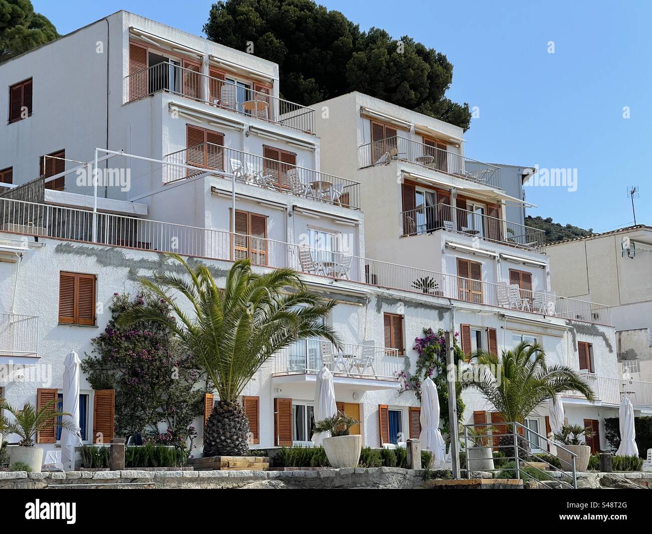 White terrasse patio houses overlooking the beach on the Mediterranean ...