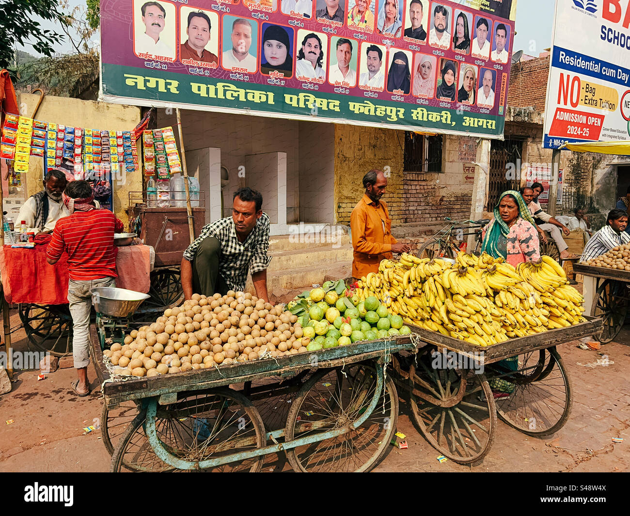 An Indian market scene full of shops and street vendors selling fruits ...