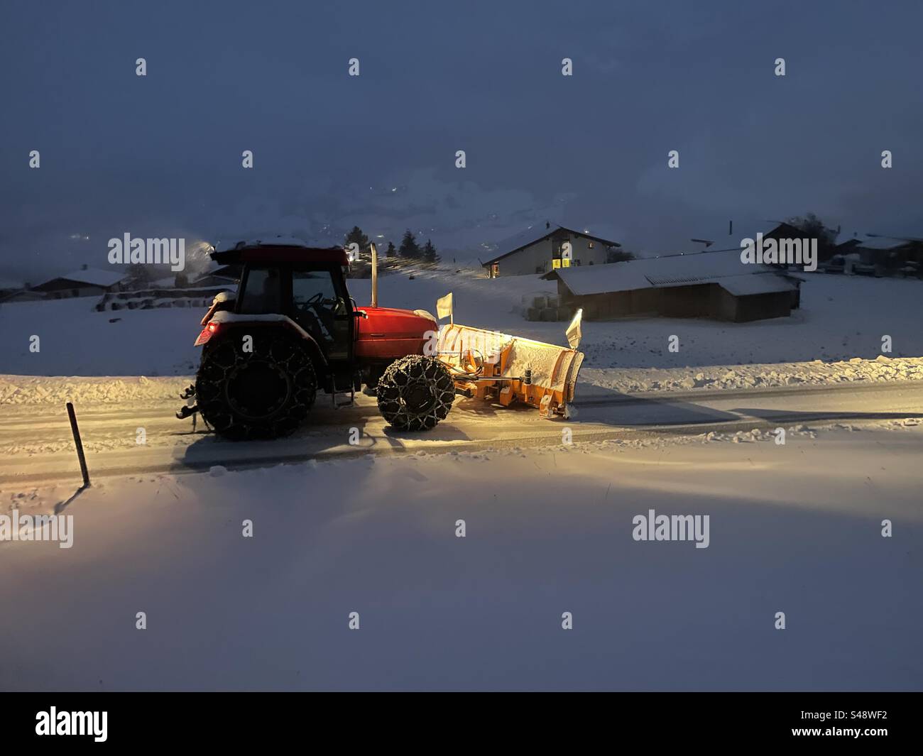 Tractor with snow plow clearing road in Bernese alps, Switzerland Stock ...