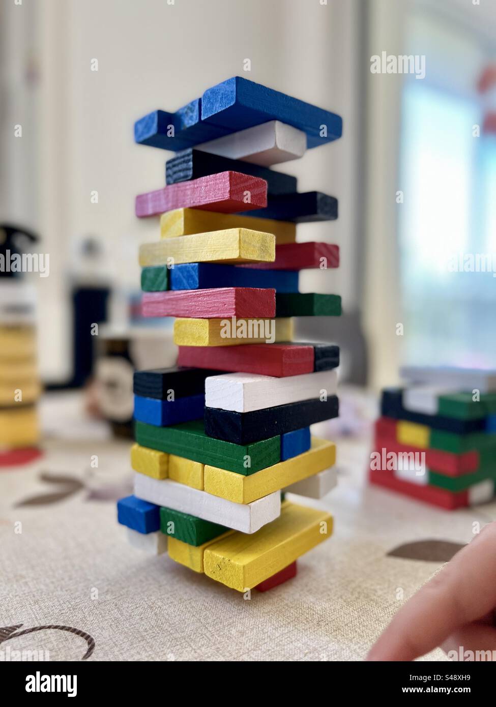 Child playing jenga table smartphone stock photos and images - Alamy