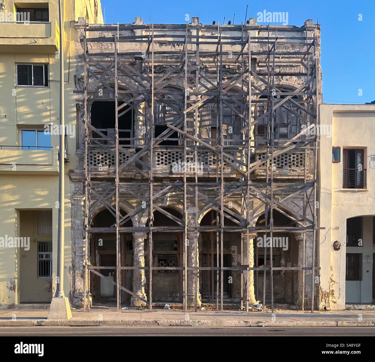 Façade of rundown building with scaffolding in Malecón, Havana, Cuba ...