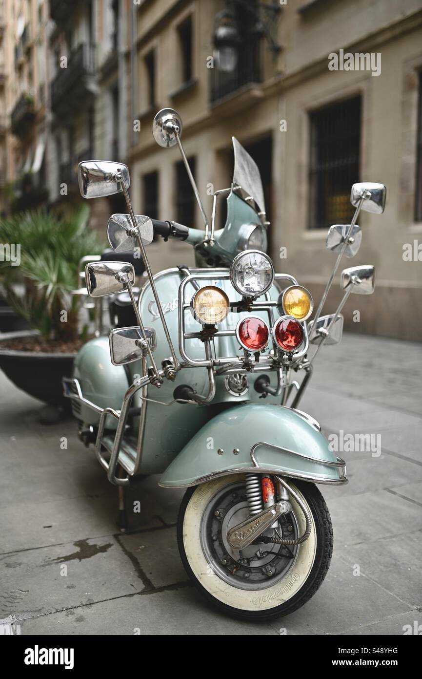 An amazing looking Vespa motorcycle covered by lights and mirrors as ...