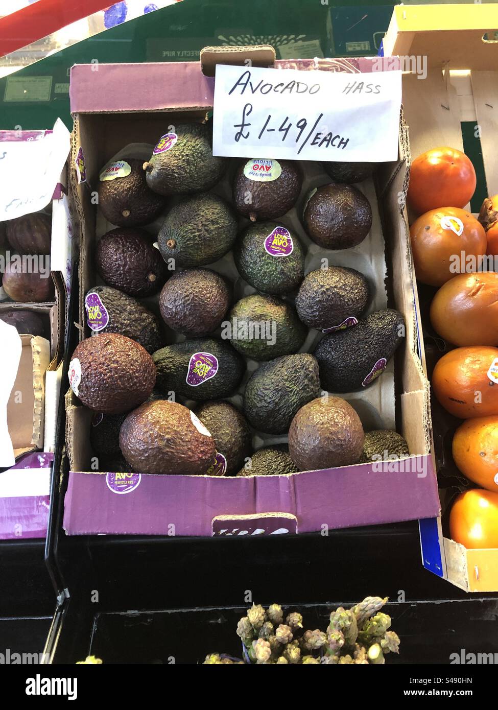 Avocados priced up for sale at local grocery Stock Photo - Alamy