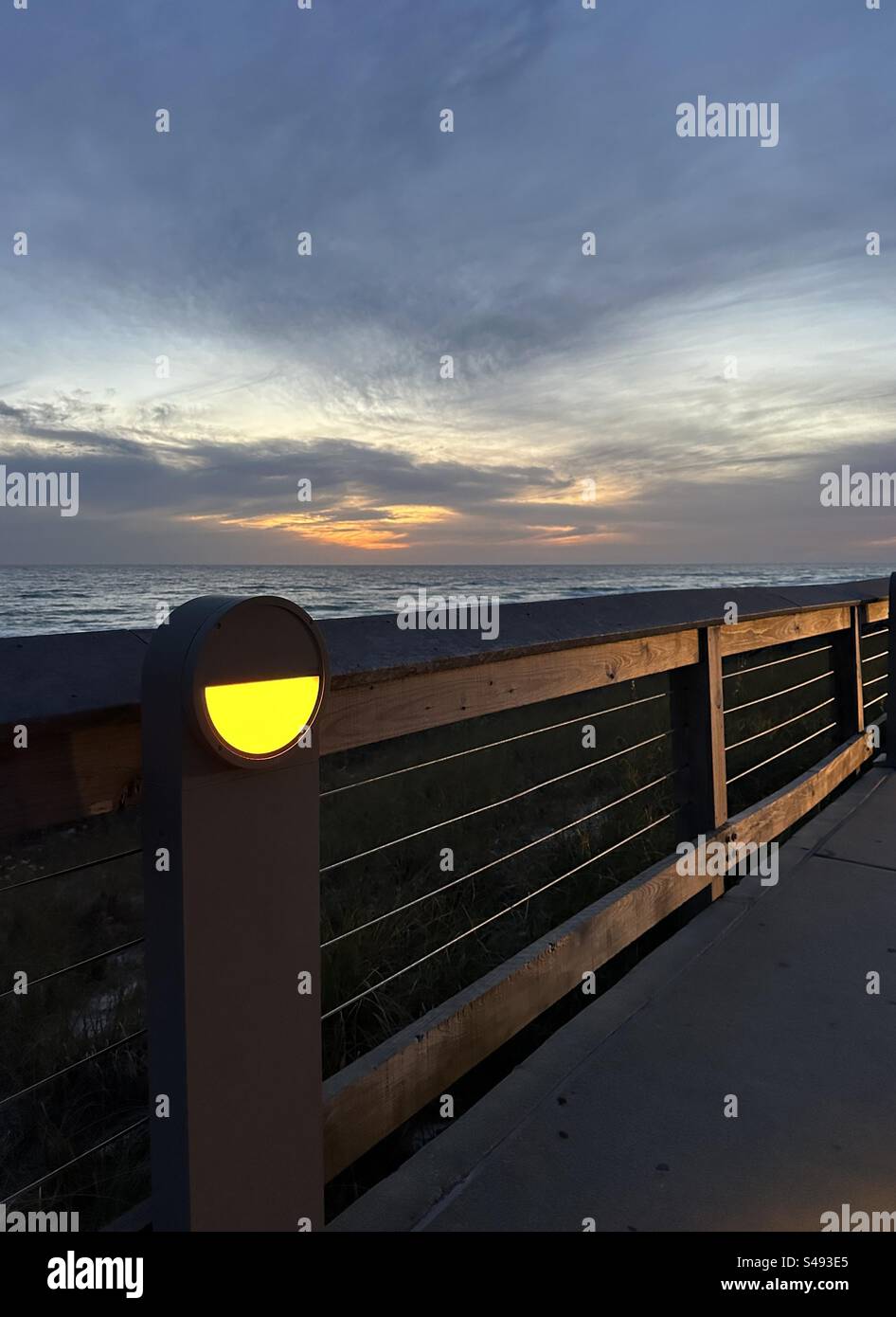 Lighted boardwalk with beach sunset background in Miramar Beach Florida ...